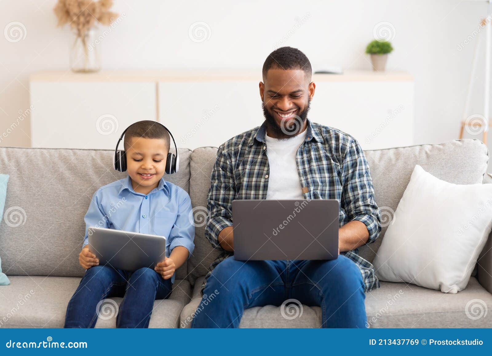 Black Father and Little Boy Using Computers Together at Home Stock ...