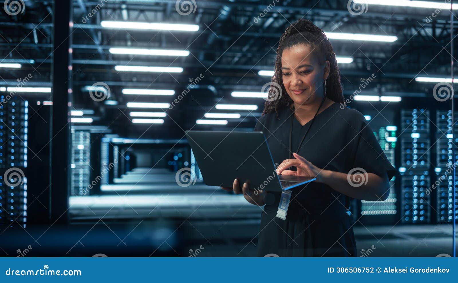 Black Female Chief Technology Office Using Laptop Computer, Standing in ...