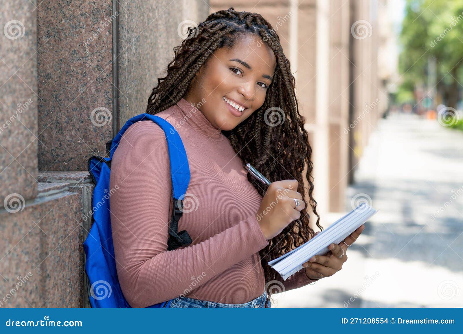 Black Female Student with Dreadlocks Writing Notes in Front of ...