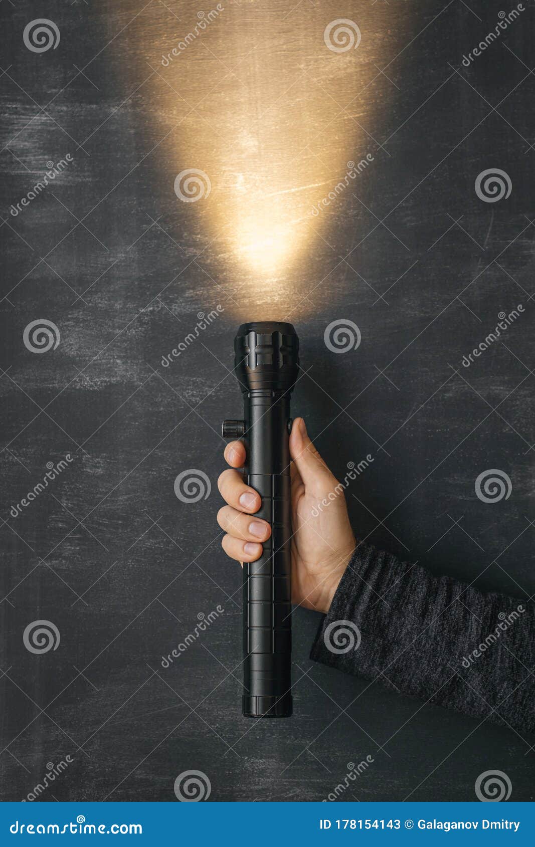 Black Flashlight in a Manâ€™s Hand and a Ray of Warm Light in the Dark ...