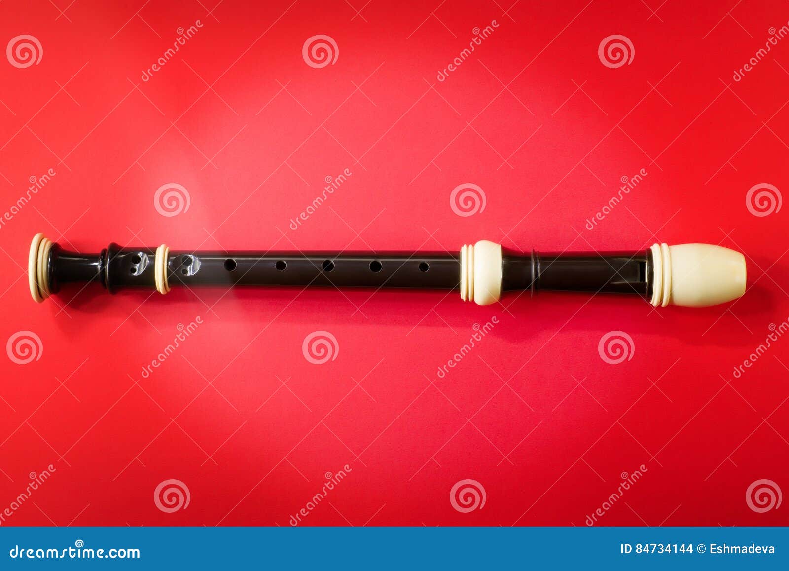 Black flute on red stock photo. Image of composition - 84734144