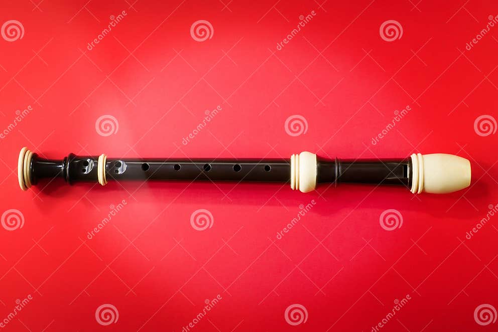 Black flute on red stock photo. Image of composition - 84734144