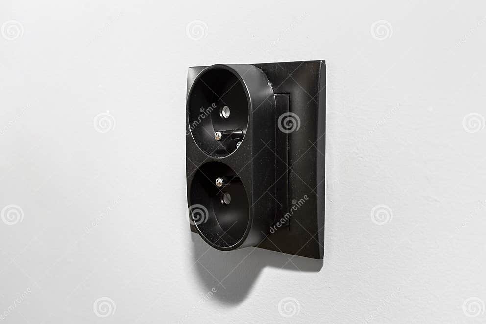 Black Frame of a Double Electrical Socket with Grounding on the Gray ...