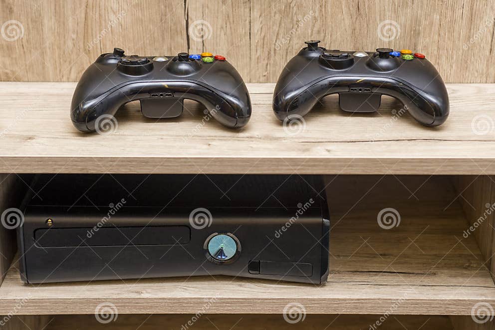 Black Game Console and Controller the Table. Game Console and Gamepad ...