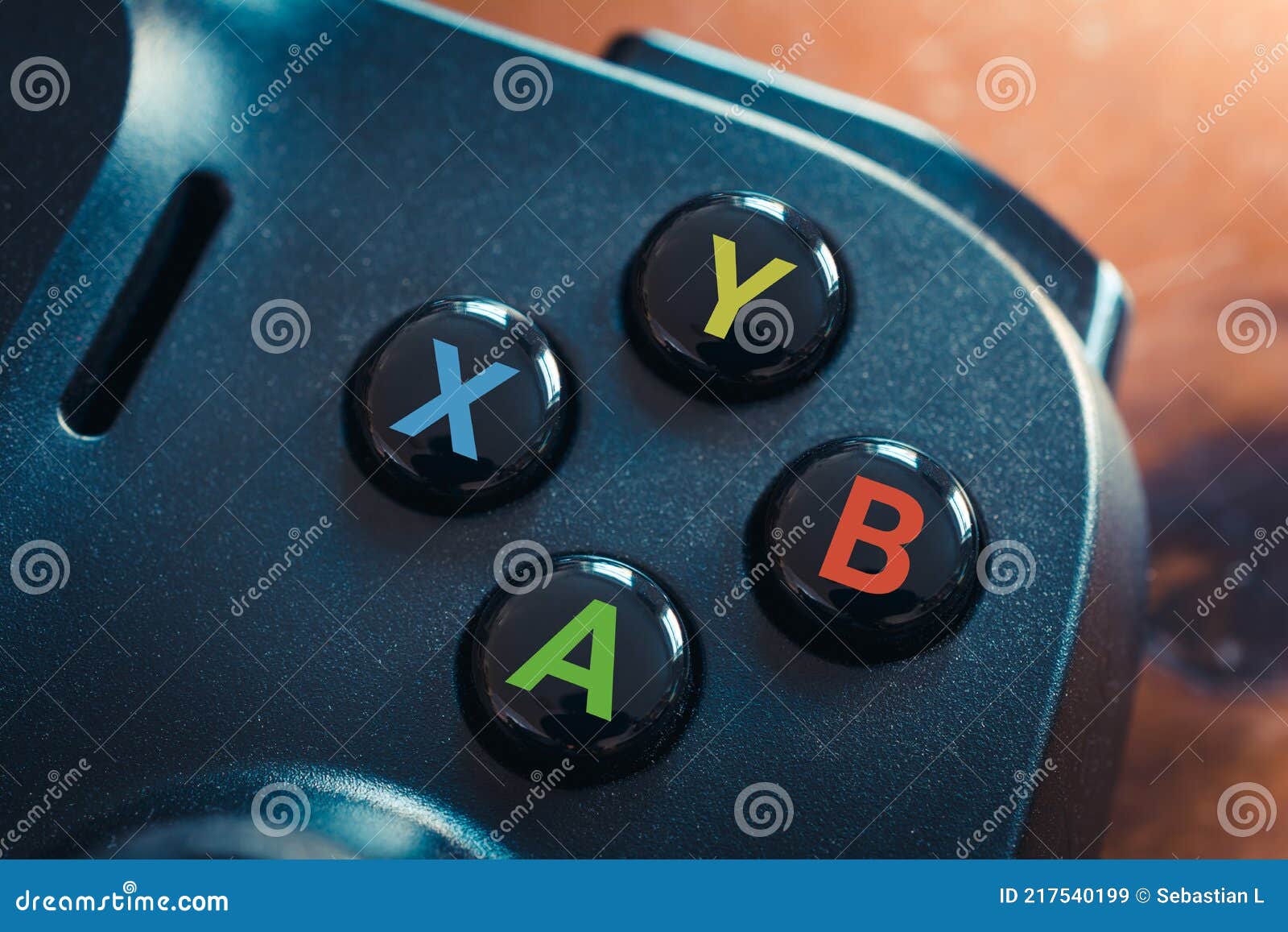 Black Gaming Controller on Table with Focus on the 4 Action Buttons a ...