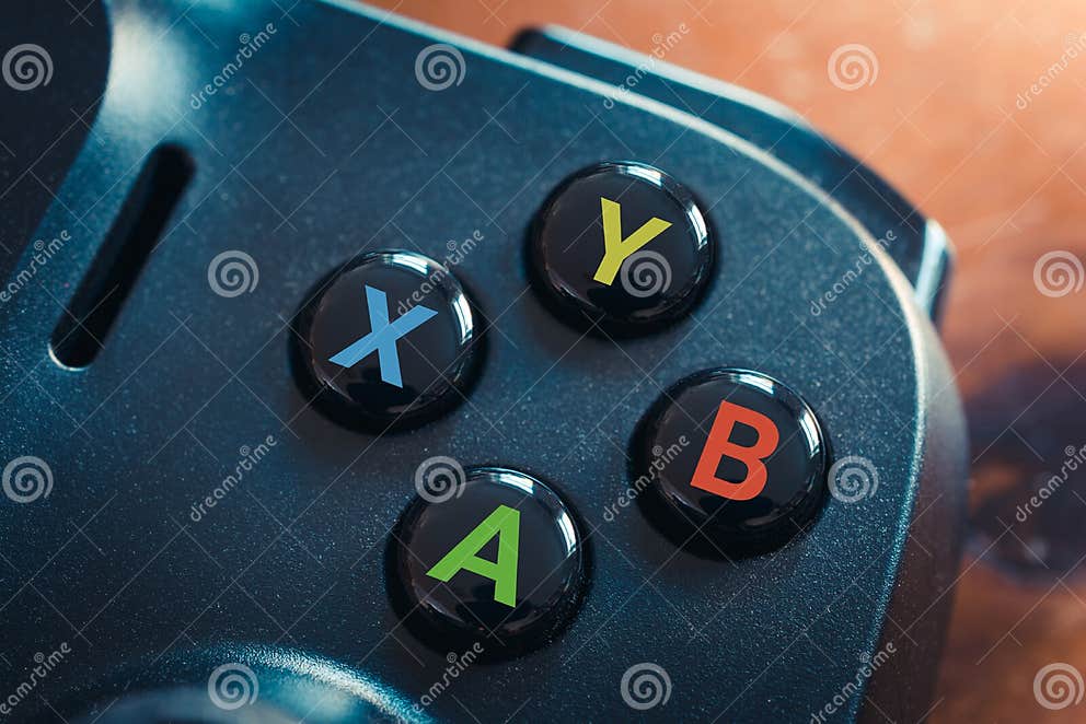Black Gaming Controller on Table with Focus on the 4 Action Buttons a ...