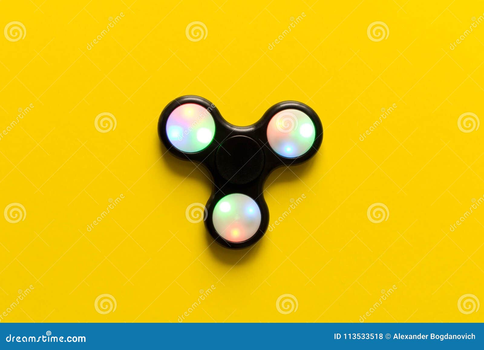 Black Glowing Spinner . Isolated on Yellow Background Stock Photo ...