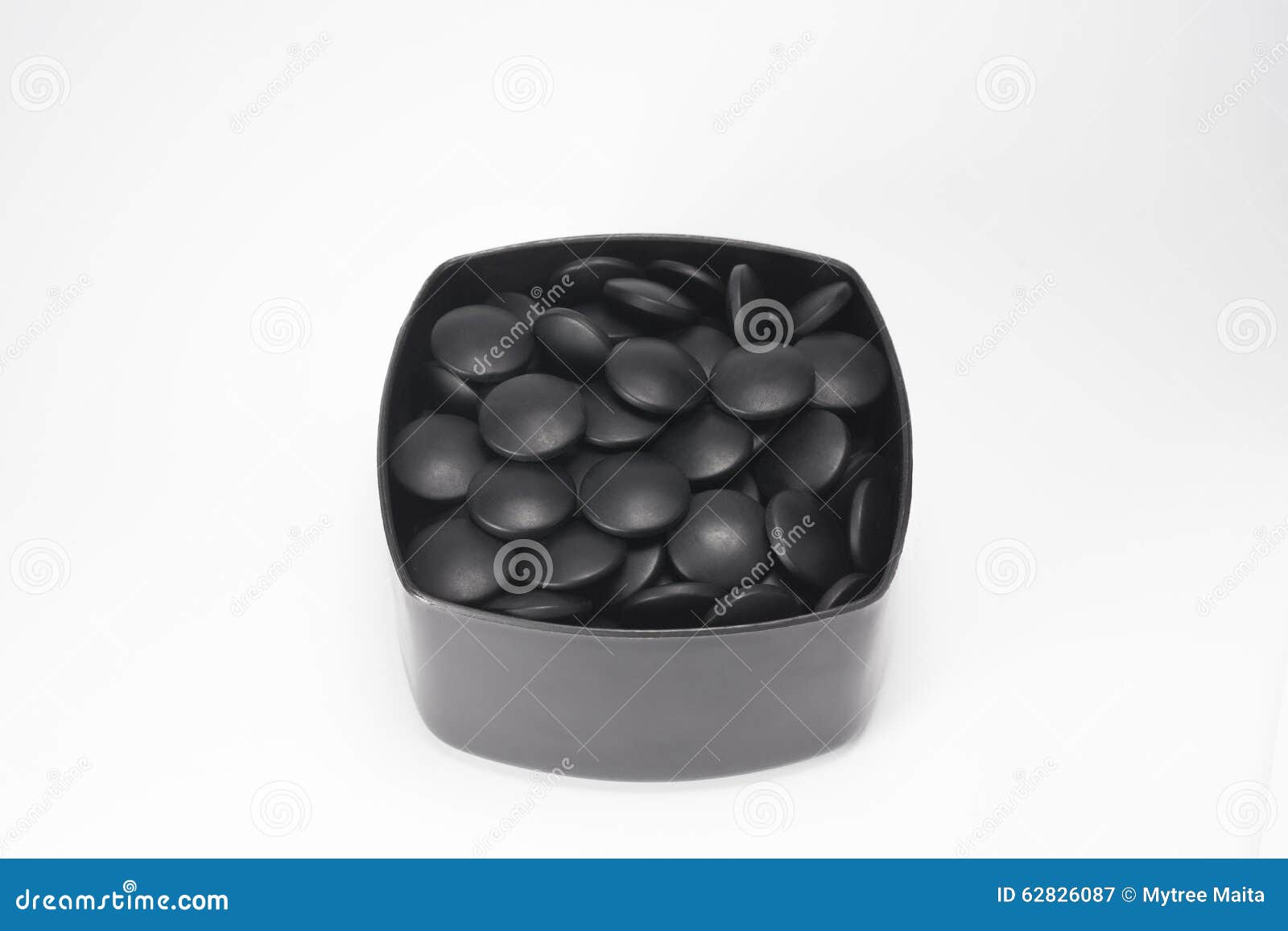 Black Go stones in a bowl. stock image. Image of board - 62826087