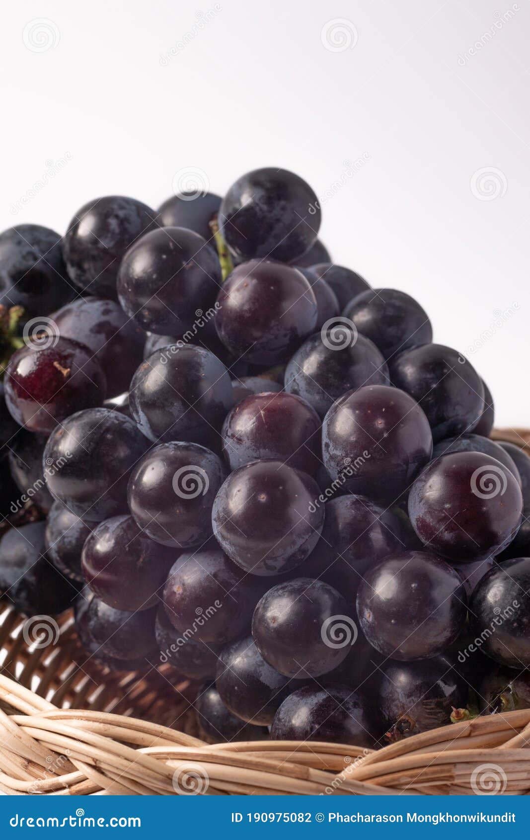Black Grapes without Seeds in a Rattan Basket. White Background Stock ...