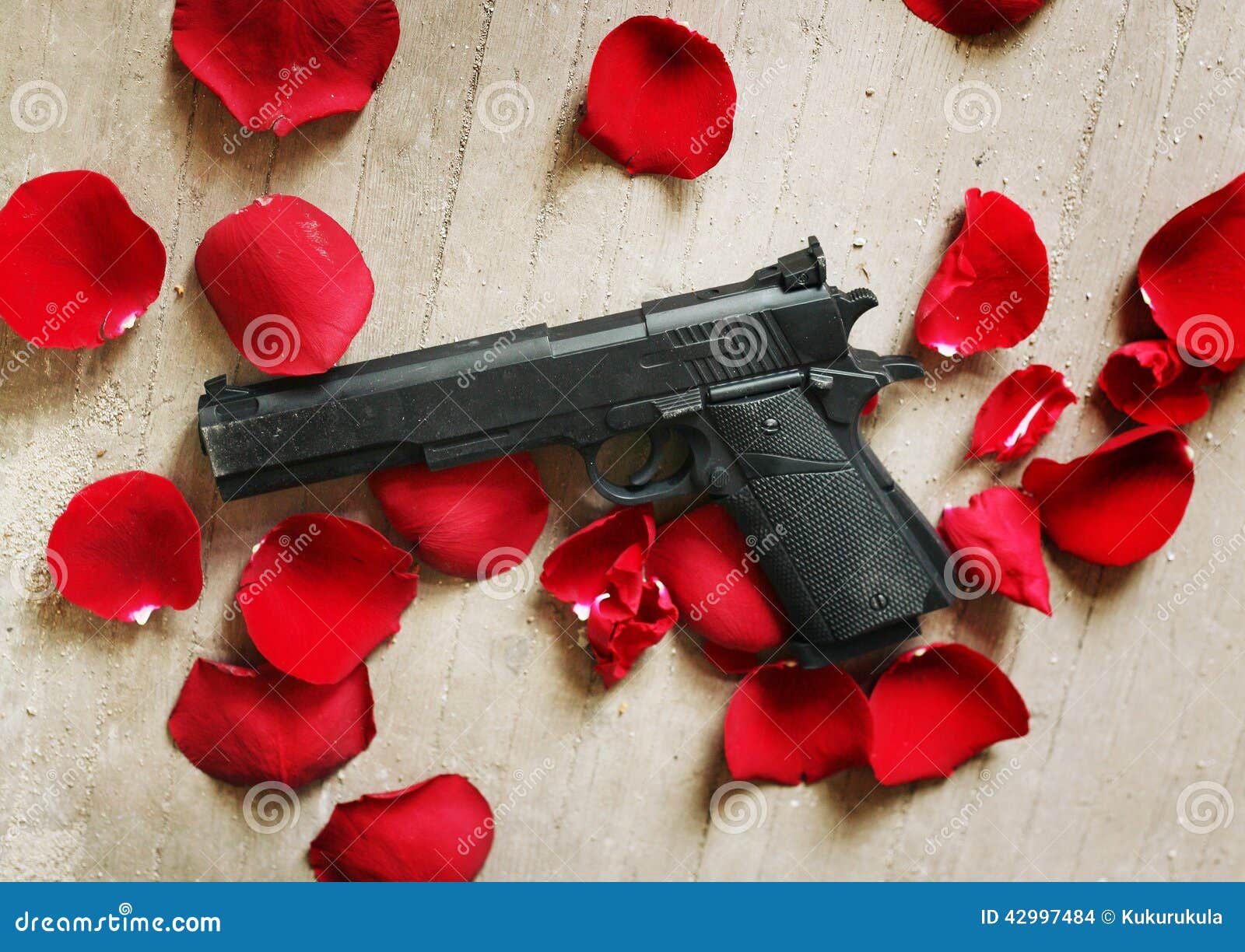 Black gun red roses petals stock photo. Image of petals - 42997484