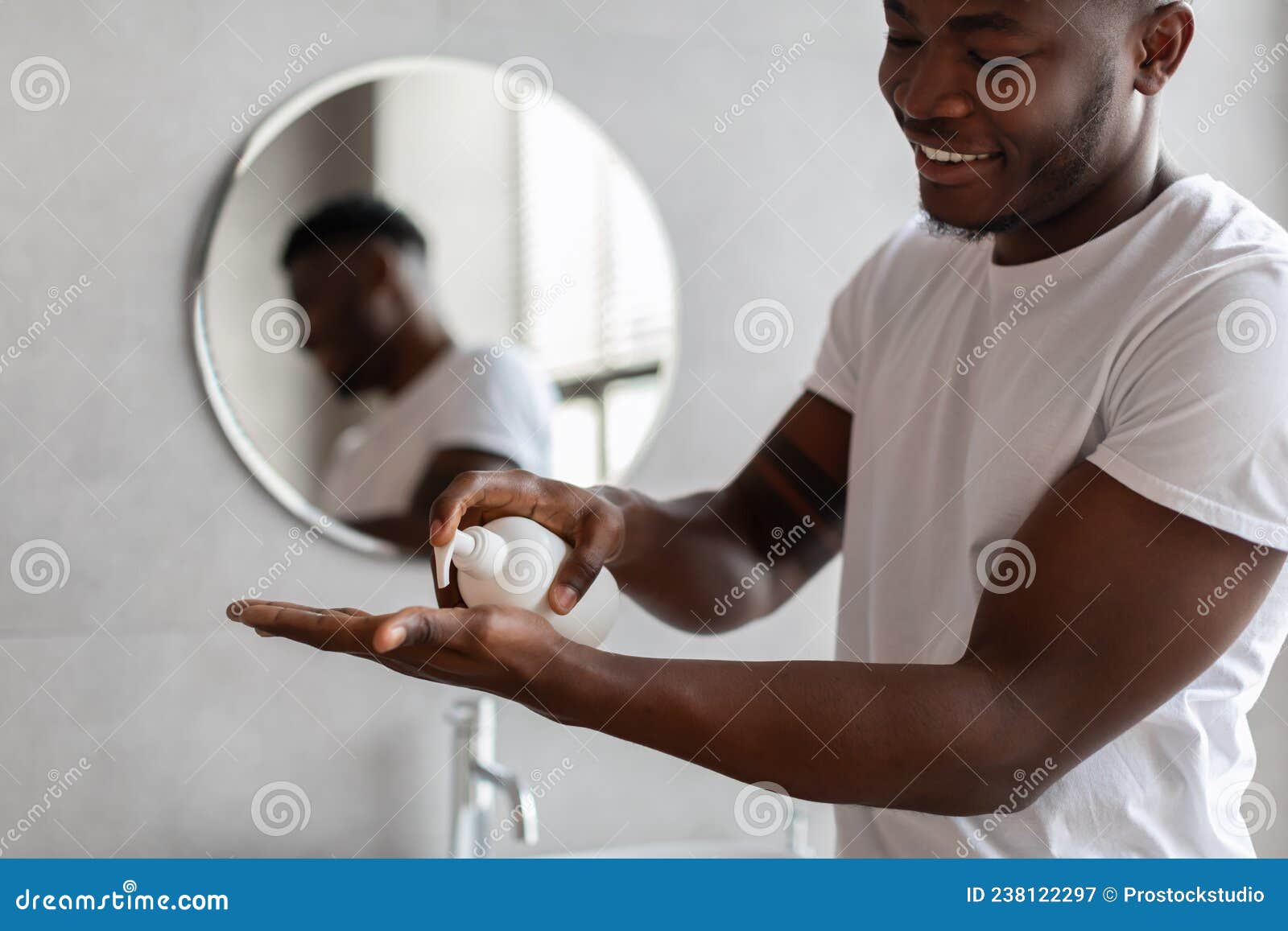 Black Guy Using Liquid Soap from Bottle in Modern Bathroom Stock Image ...
