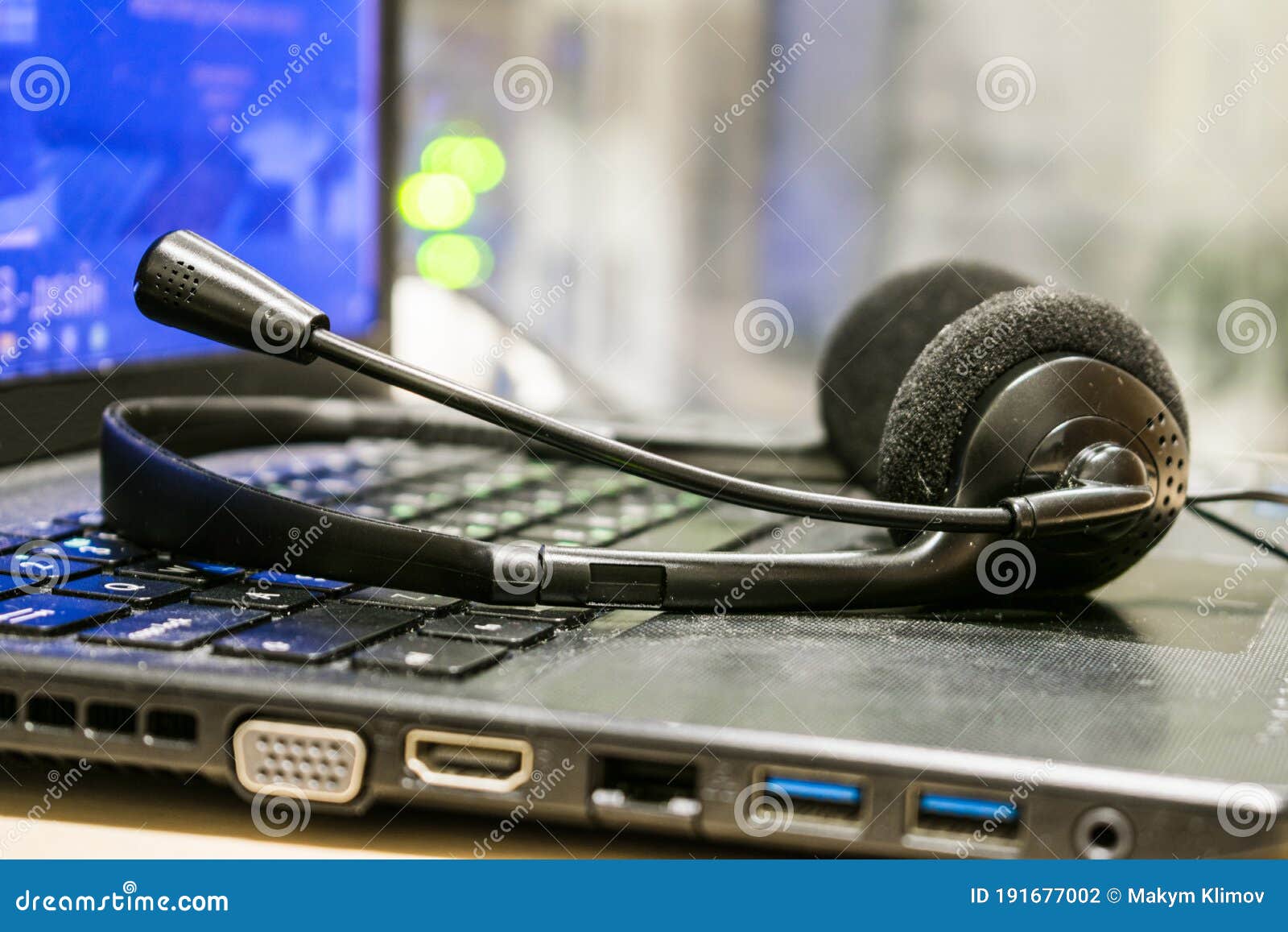 Black Headphones and a Microphone are on the Laptop. Technical Support ...