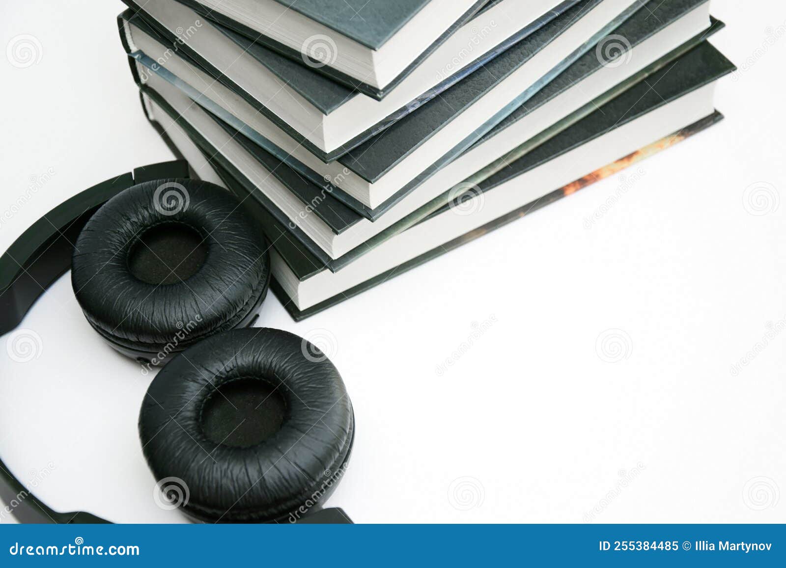 Black Headphones with Stack of Books on Light Background. Stock Image ...