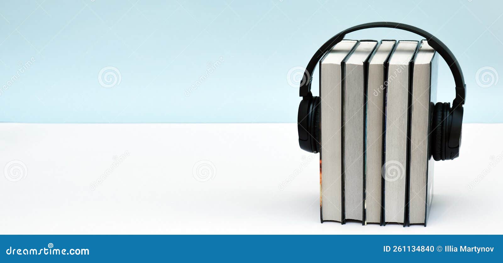 Black Headphones with Stack of Books on Light Background. Stock Photo ...