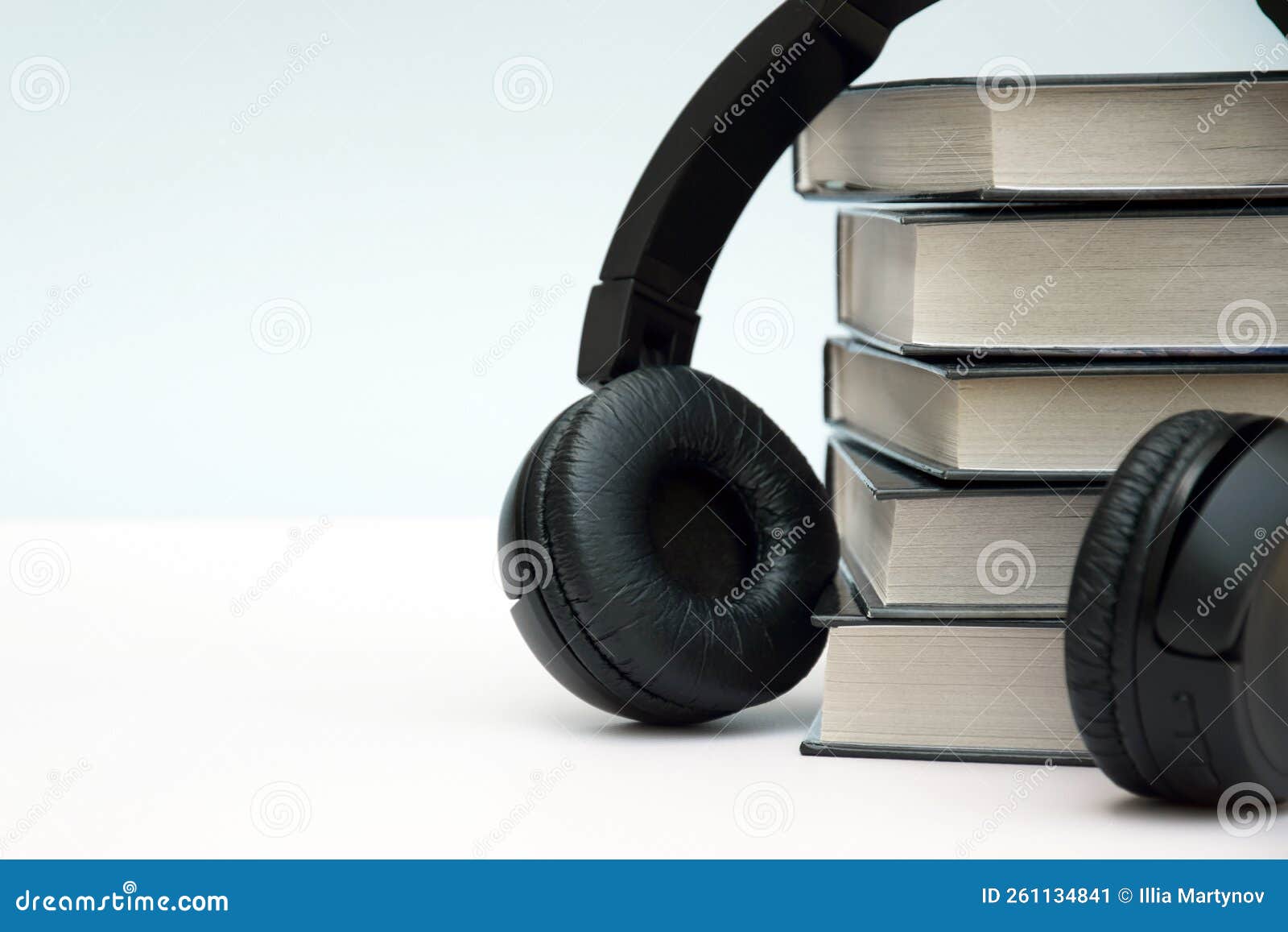 Black Headphones with Stack of Books on Light Background. Stock Image ...