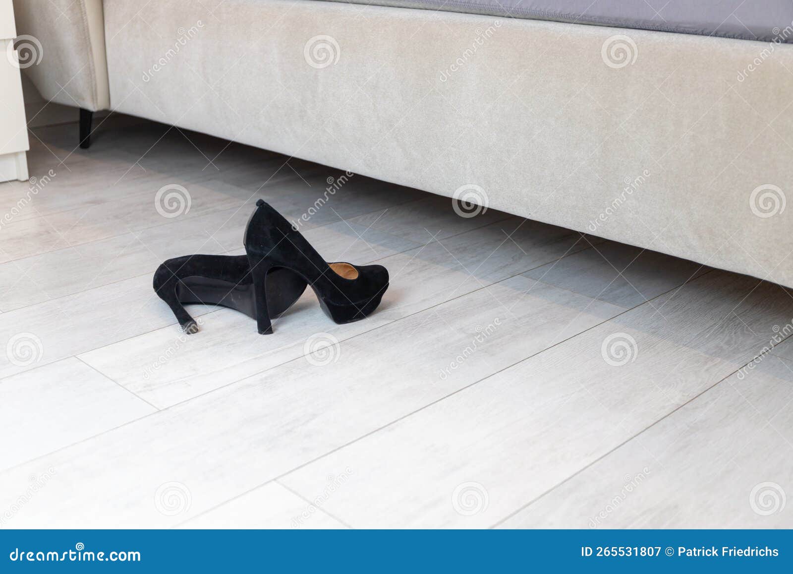 Black High Heels in Front of a Bed Stock Image - Image of shoe, front ...