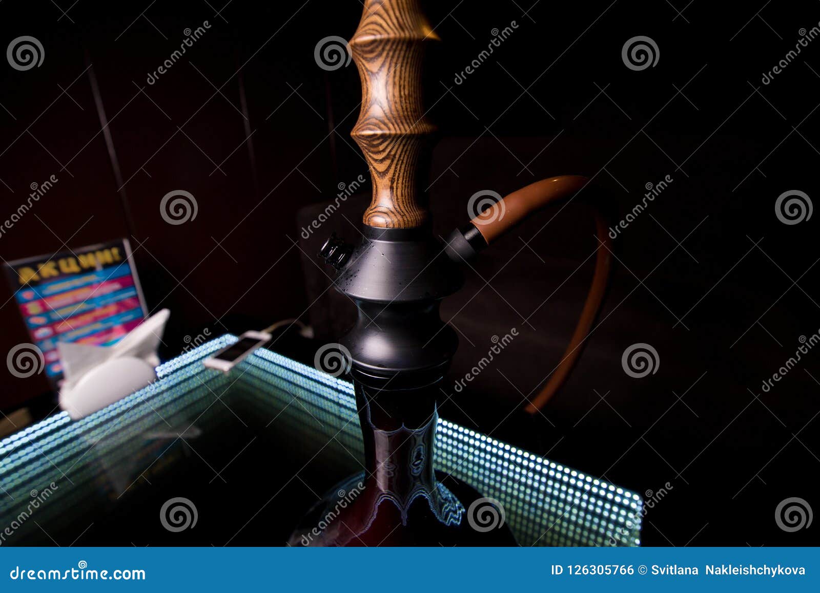 A Black Hookah Stands on a Glass Table Stock Photo - Image of light ...