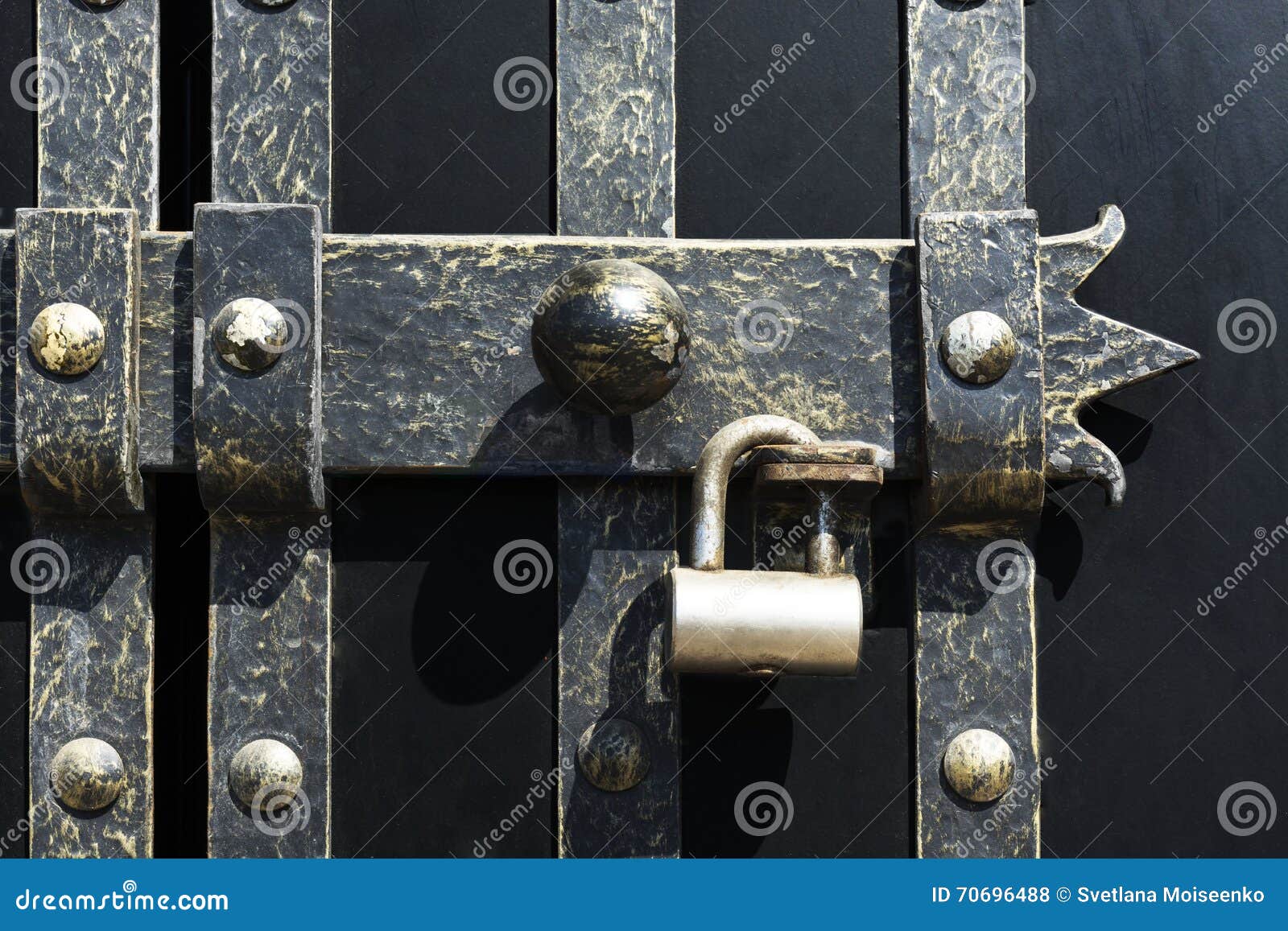 Black Iron Gate, Brass Squares and a Lock with Latch Stock Photo ...