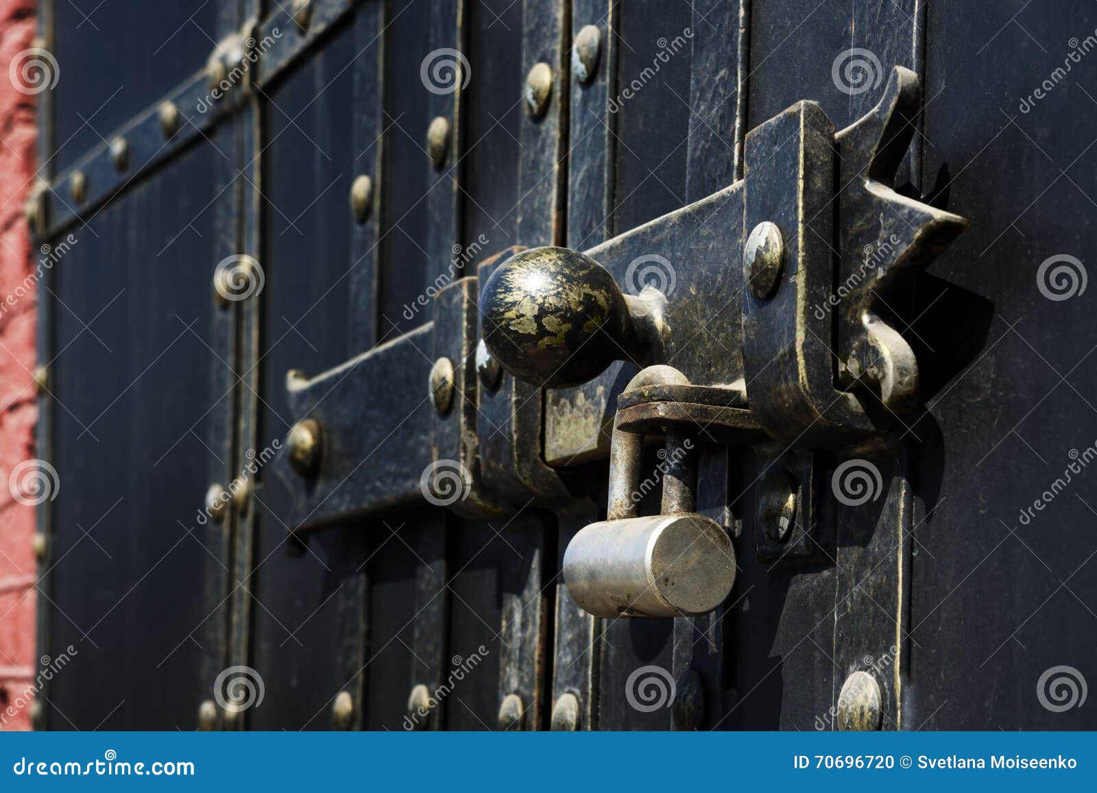 Black Iron Gate, Brass Squares and a Lock with Latch Stock Photo ...