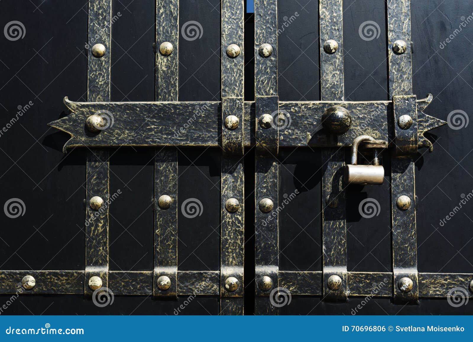 Black Iron Gate, Brass Squares and a Lock with Latch Stock Photo ...