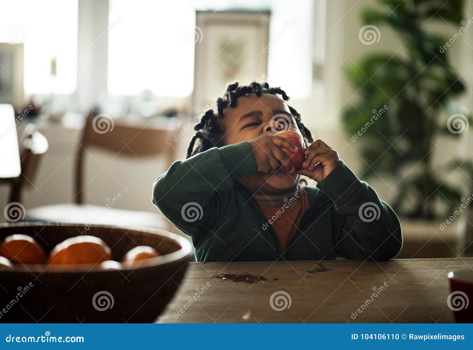 Black kid eating fruit stock photo. Image of yuletide - 104106110