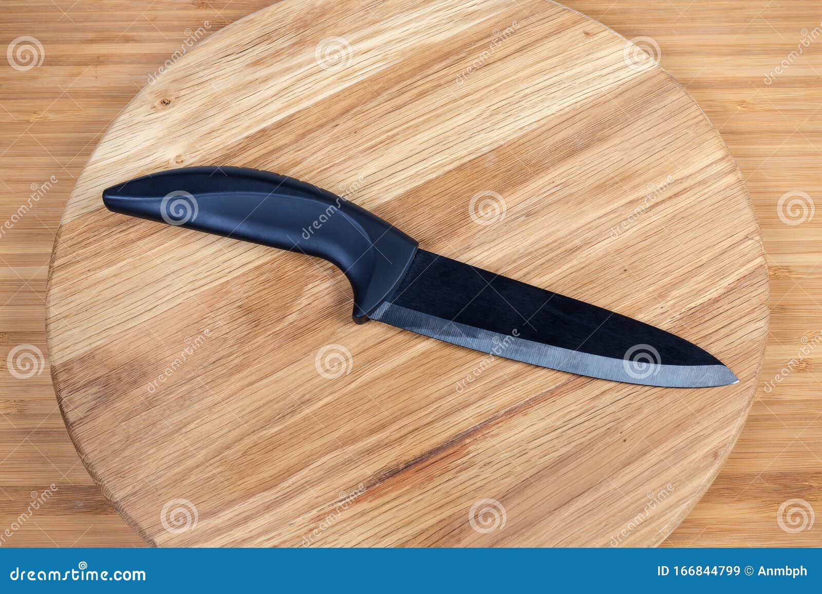 Black Kitchen Ceramic Knife on Wooden Serving Board, Top View Stock ...