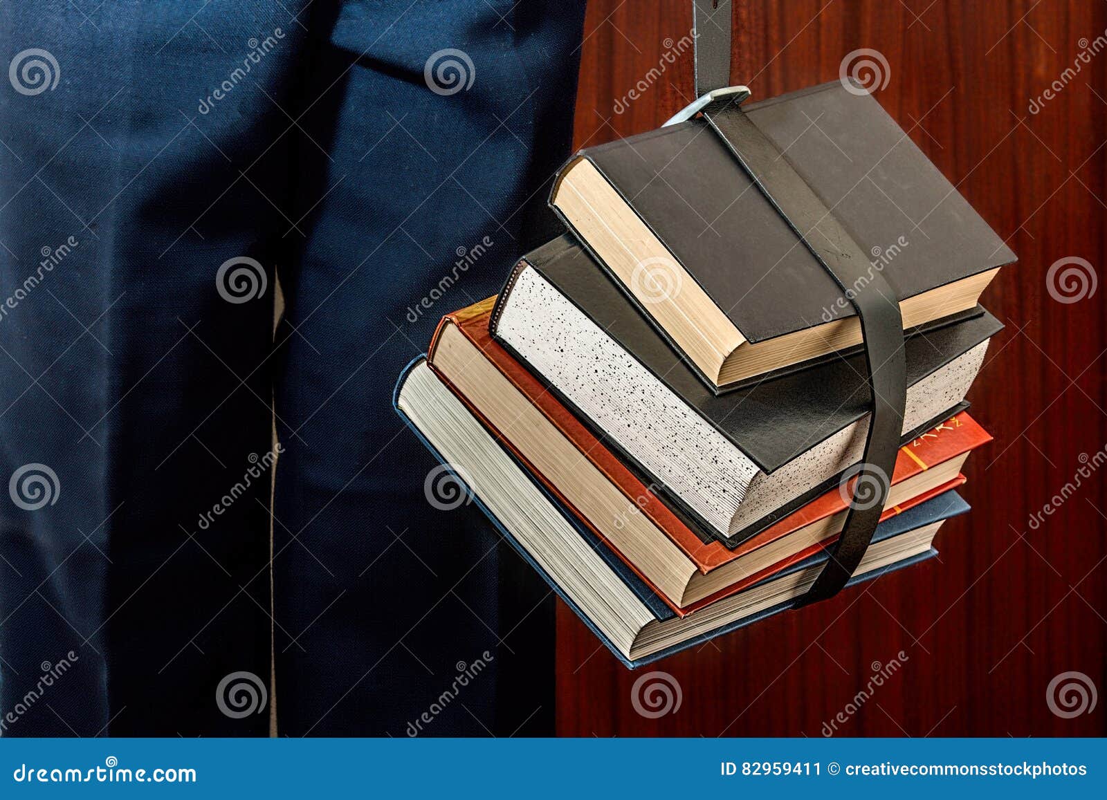 Black Leather Book Strapped Around Four Books Picture. Image: 82959411