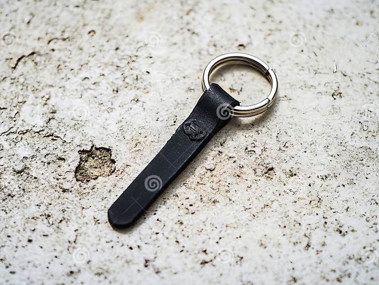 A Black Leather Keychain Sitting on a Concrete Surface Stock Photo ...
