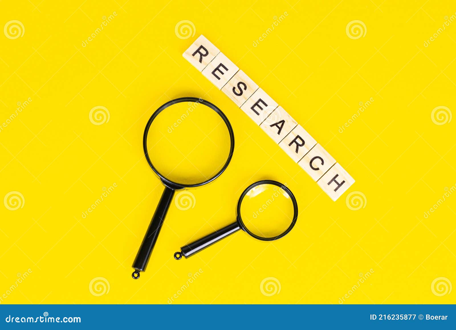 Black Magnifying Glass with Research Text on Light Yellow Background ...