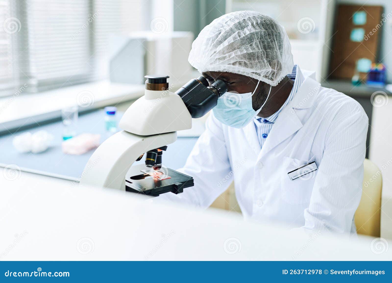 Black Male Scientist Looking in Microscope Working in Laboratory Stock ...