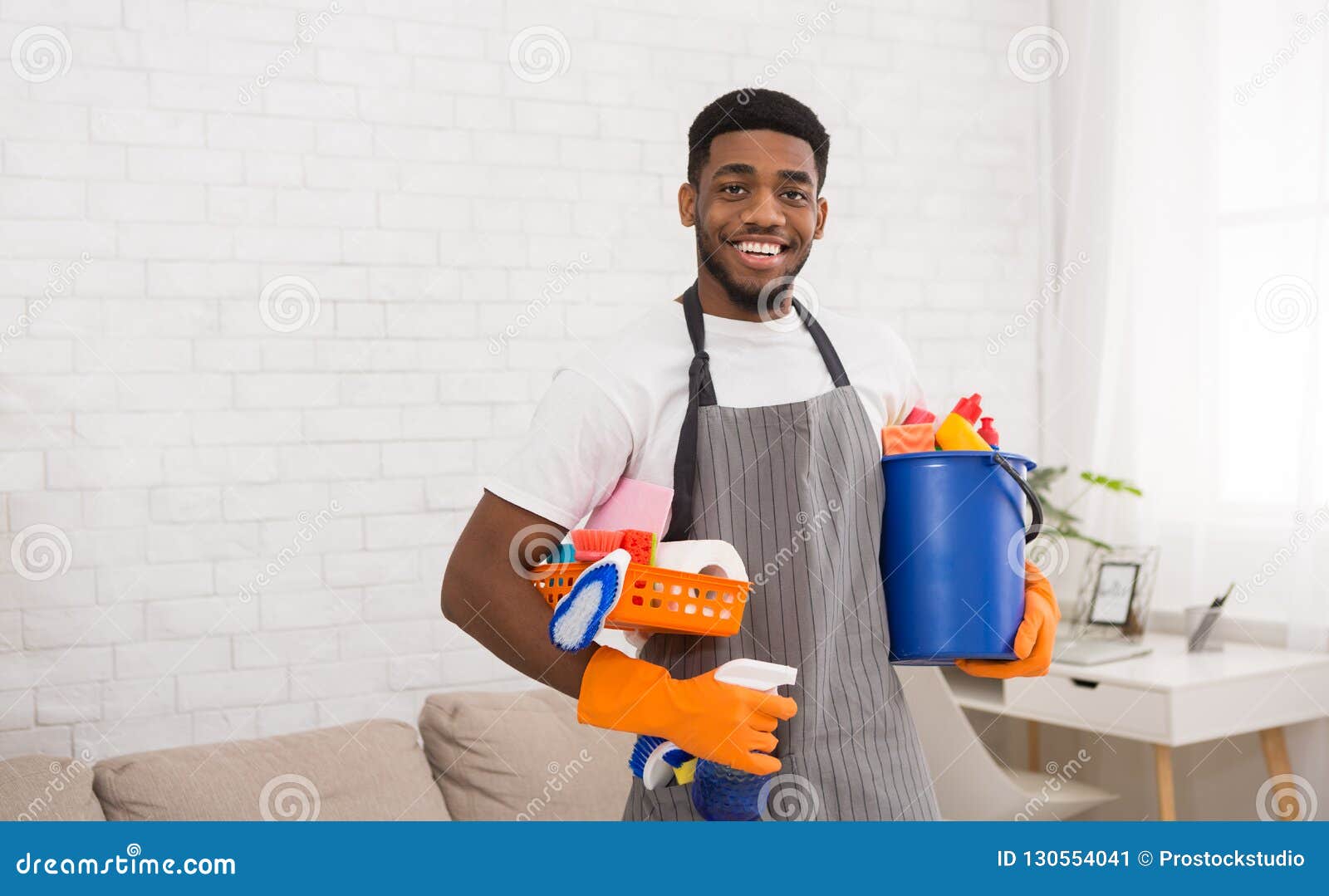 Black Man Holding Sponges And Detergents In Washing Gloves Stock Image