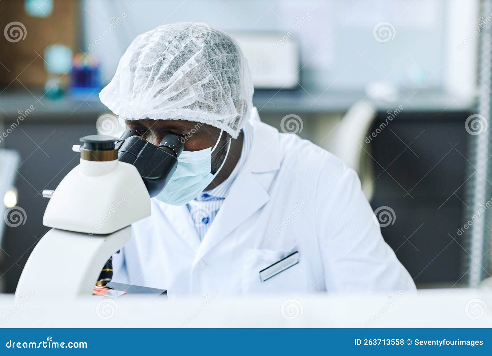 Black Man Looking in Microscope and Working on Research in Lab Stock ...