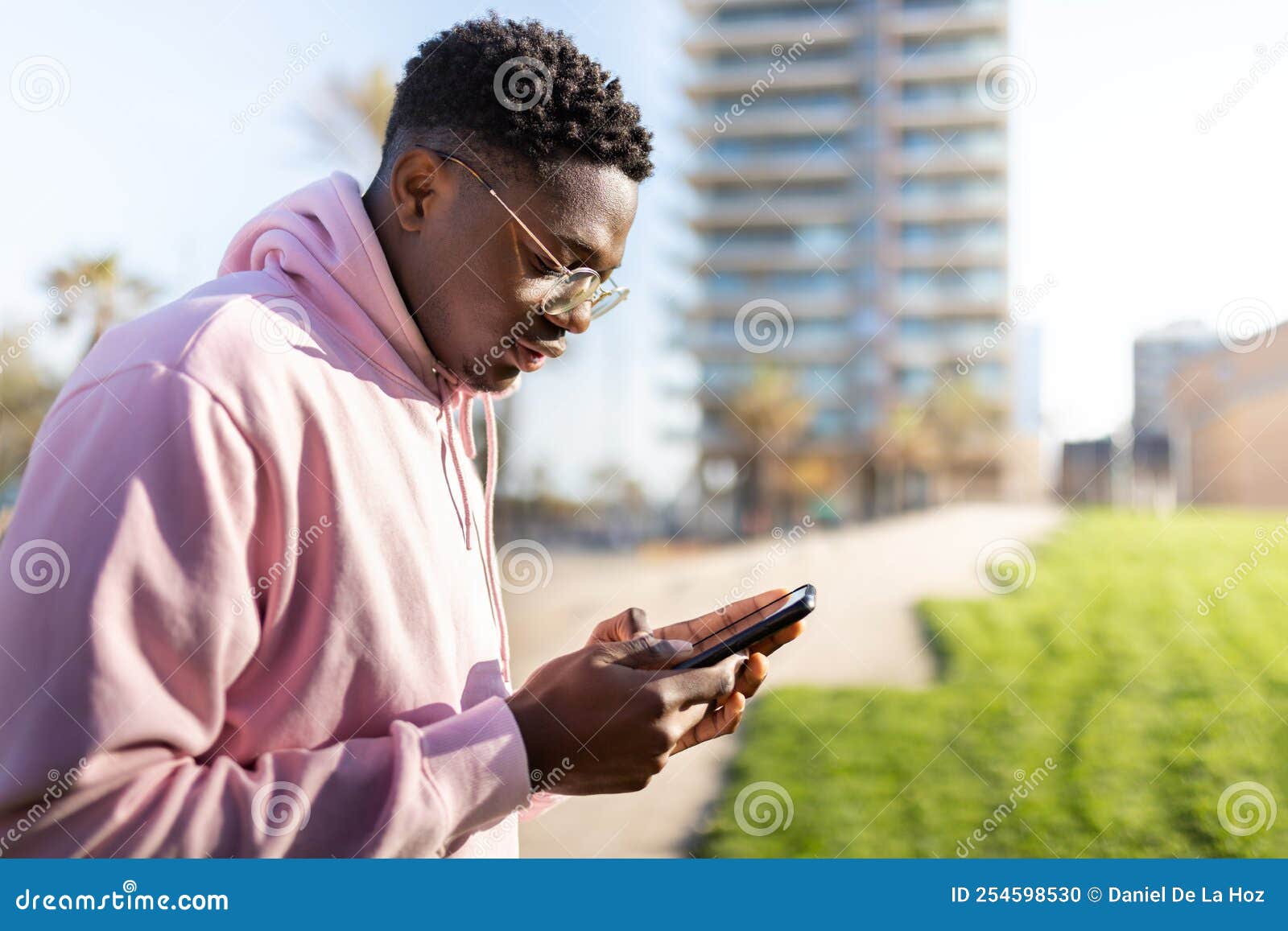 Black Man Outdoors Using Mobile Phone To Send Text Message. Copy Space ... Black Man Outdoors Using Mobile Phone To Send Text Message. Copy Space ...
