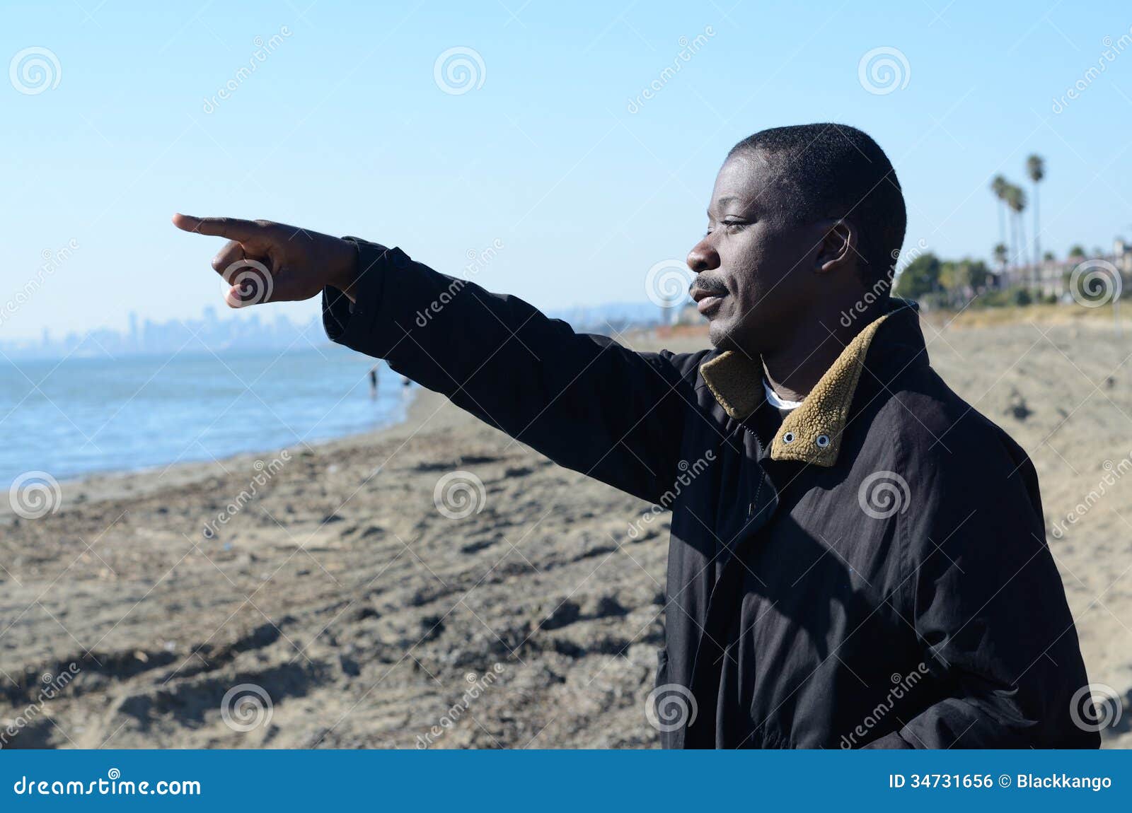 Black Man Pointing To the Ocean Stock Photo - Image of francisco, coat ...