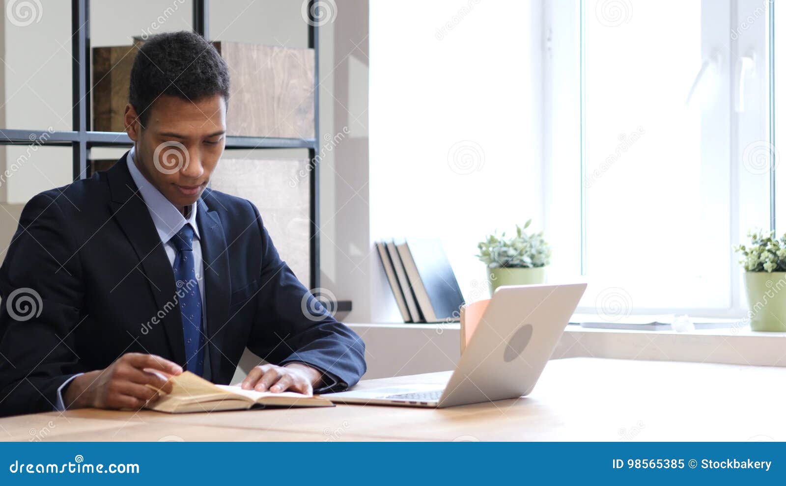 Black Man Reading Book stock image. Image of work, posture - 98565385