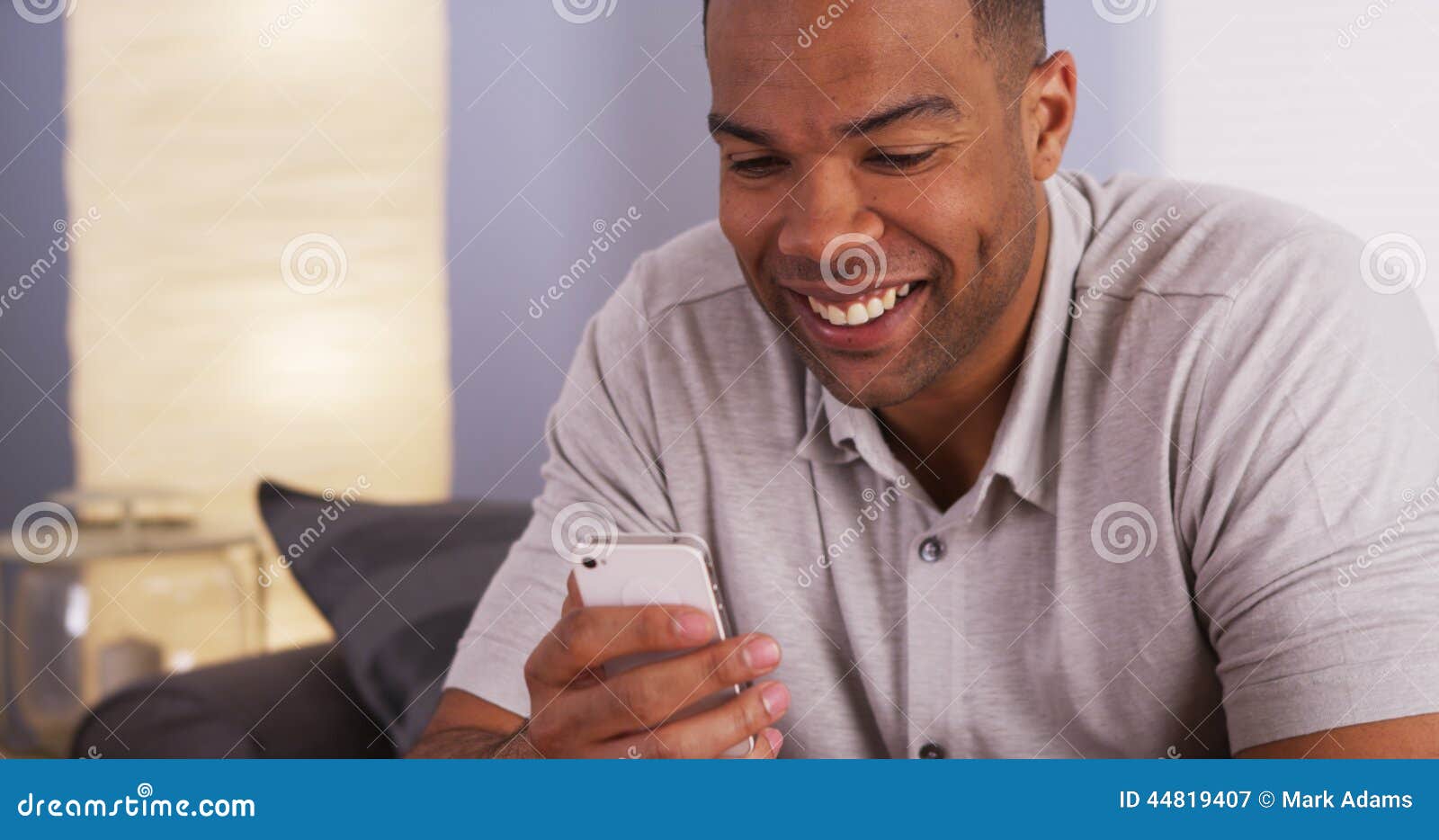 Black Man Smiling and Texting on Smartphone Stock Image - Image of ...