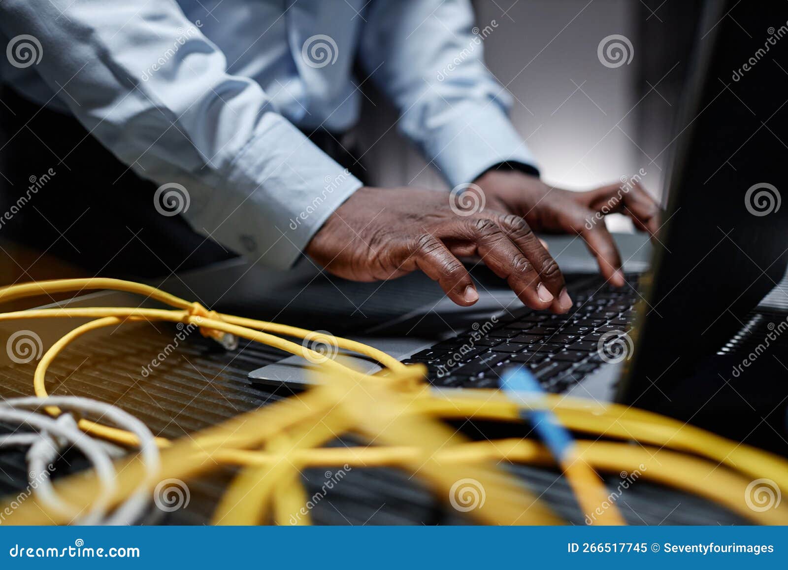 Black Man Typing at Laptop Keyboard in Server Room Stock Image - Image ...