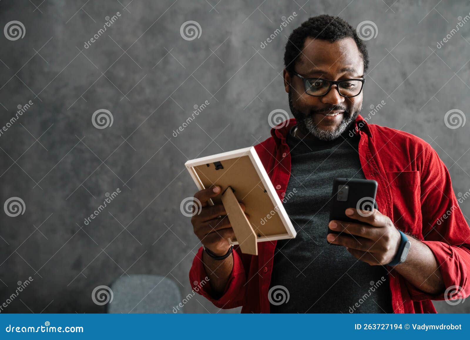 Black Man Using Mobile Phone while Working in Office Stock Photo ...