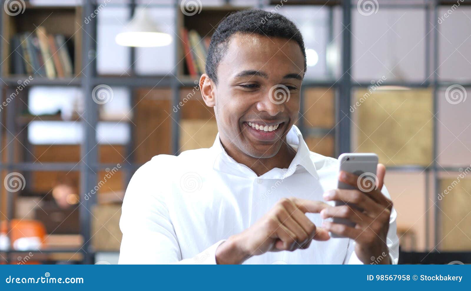 Black Man Using Smartphone at Work Stock Photo - Image of casual, phone ...