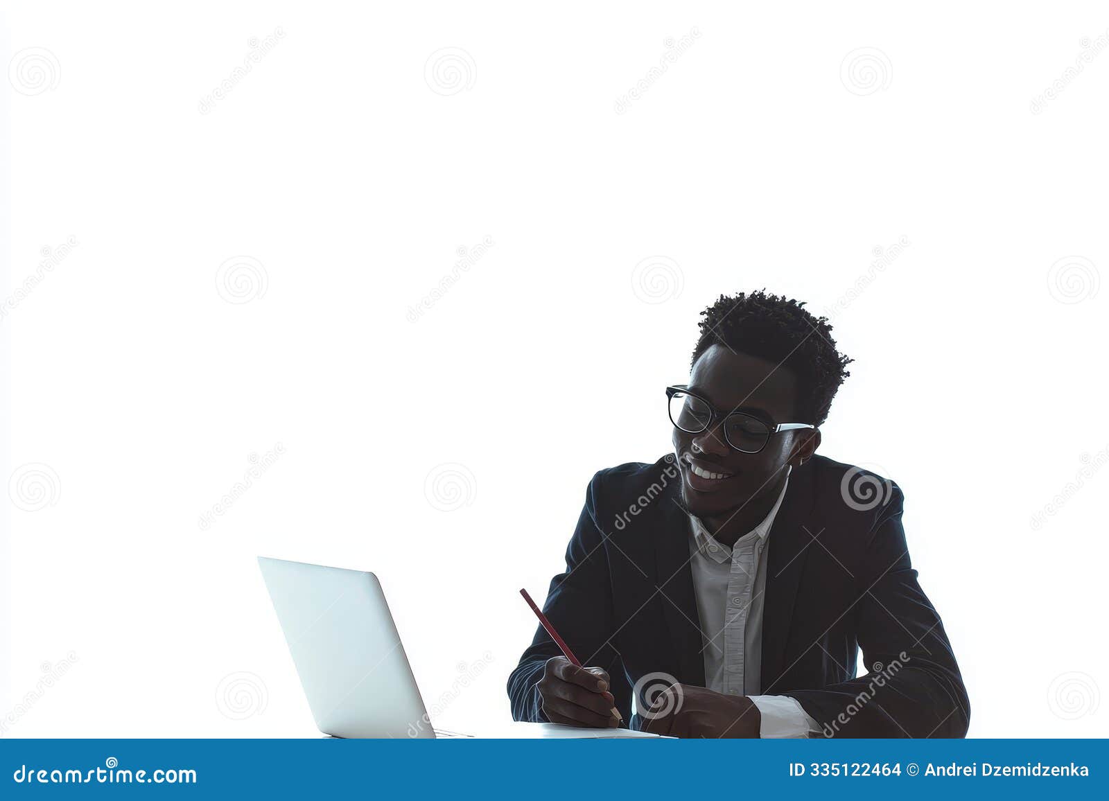 Black Man Working at Desk with Laptop and Pen, Engaged in Creative or ...