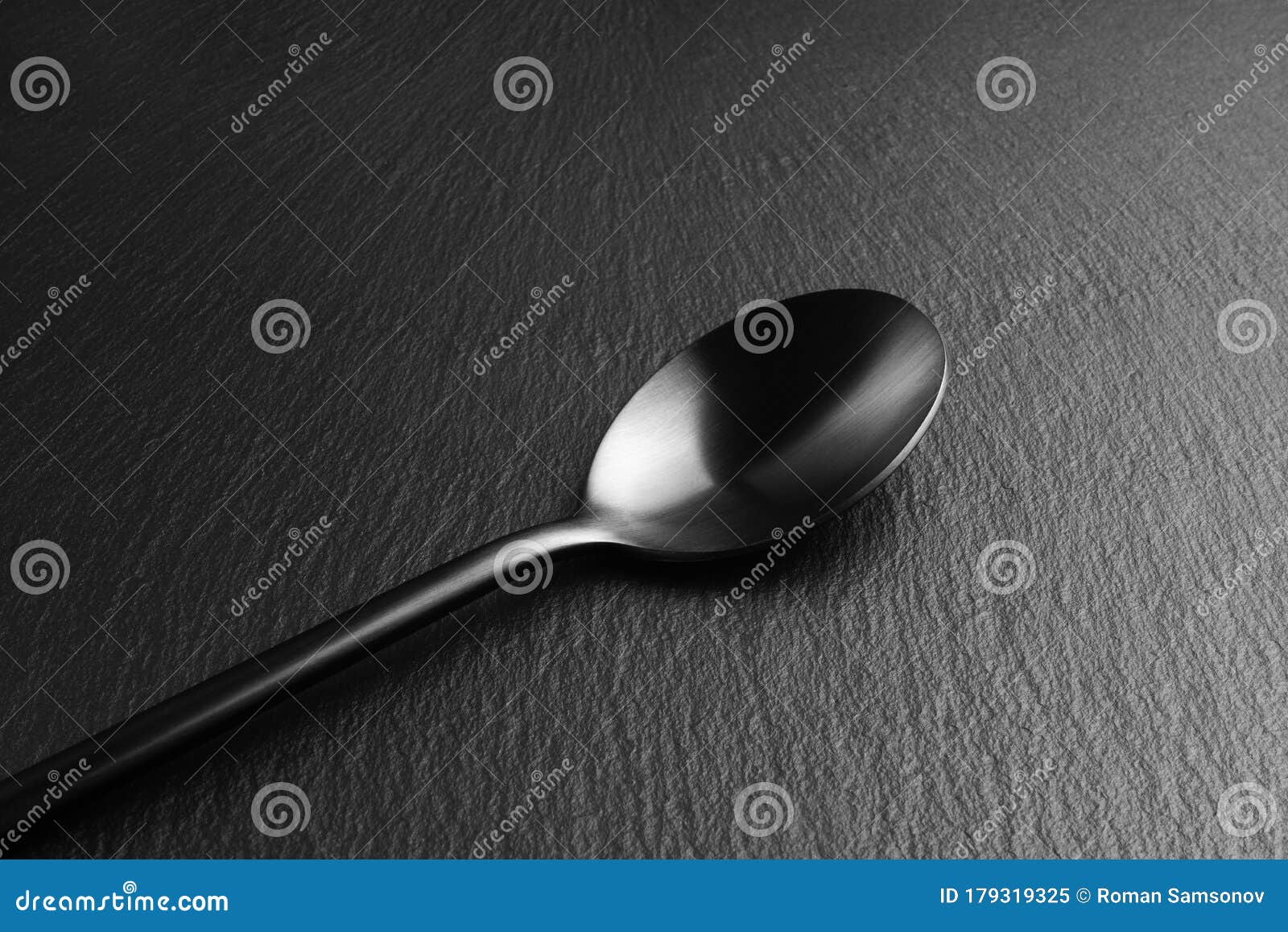 A Black Matte Spoon Rests on a Black Slate. Close Up Stock Image ...