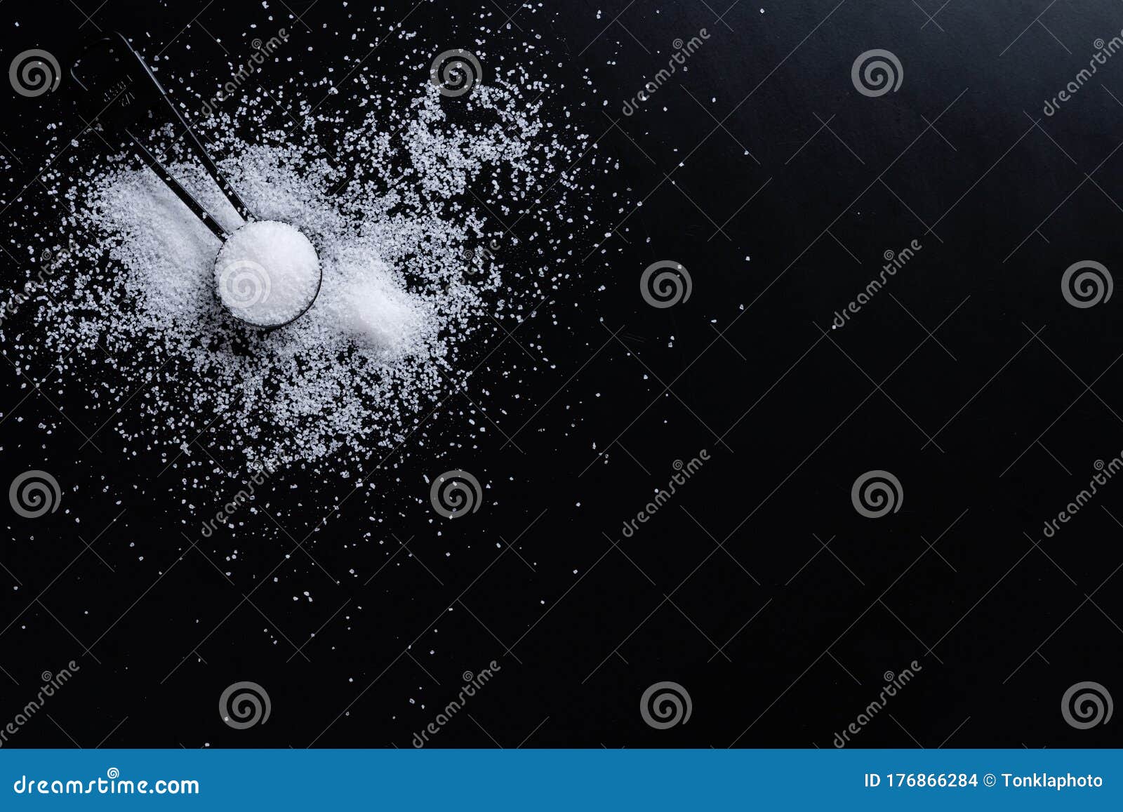 Black Measuring Spoons with Salt on Black Background Stock Photo ...