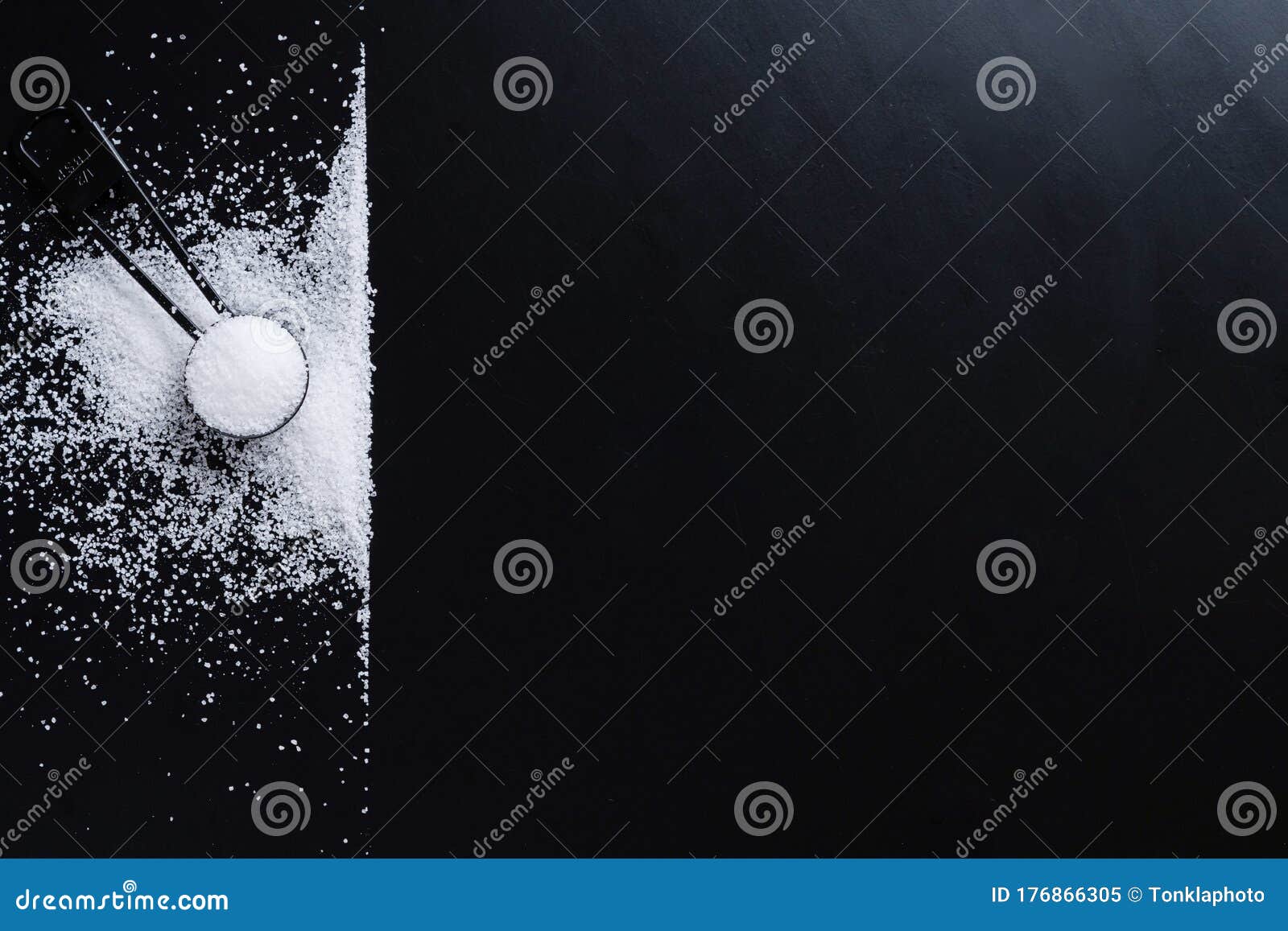 Black Measuring Spoons with Salt on Black Background Stock Image ...