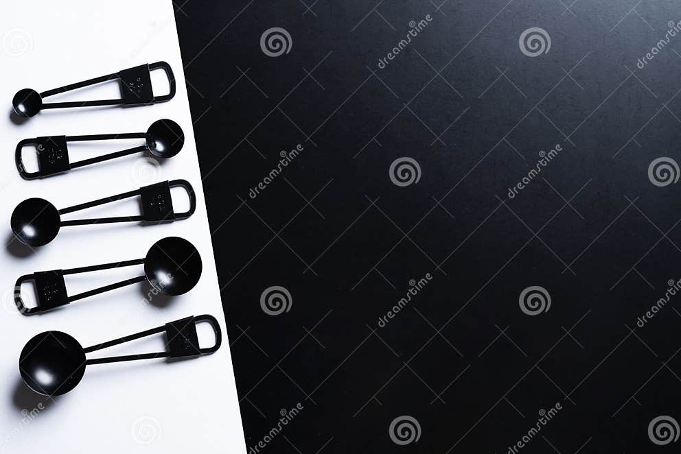 Black Measuring Spoons on Black and White Background Stock Photo ...