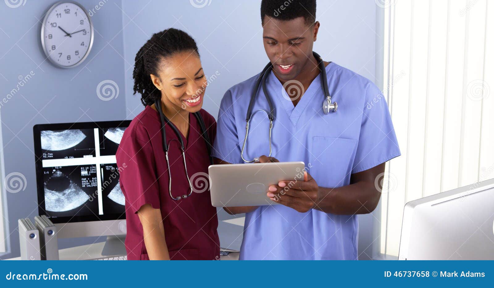 Black Medical Team Working Together on Tablet Stock Photo - Image of ...