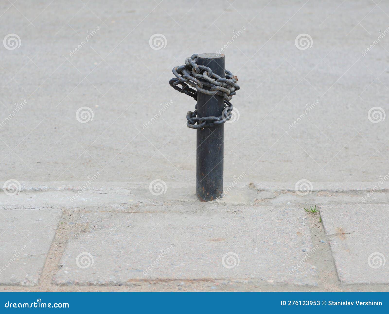 Black Metal Post Driven into the Pavement is Wrapped with a Metal Chain ...