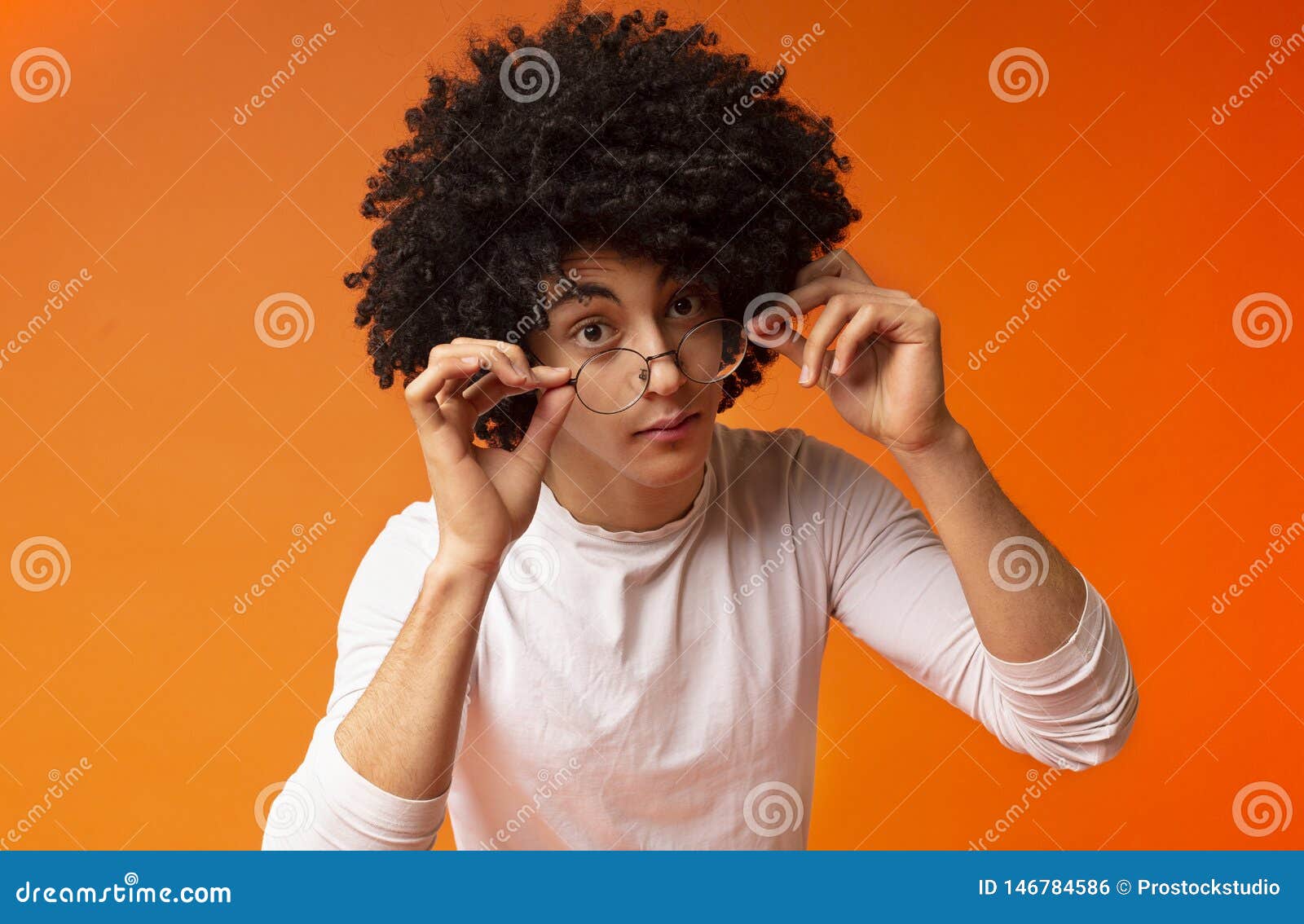 Black Millennial Guy Looking Skeptically, Lowing His Glasses Stock ...