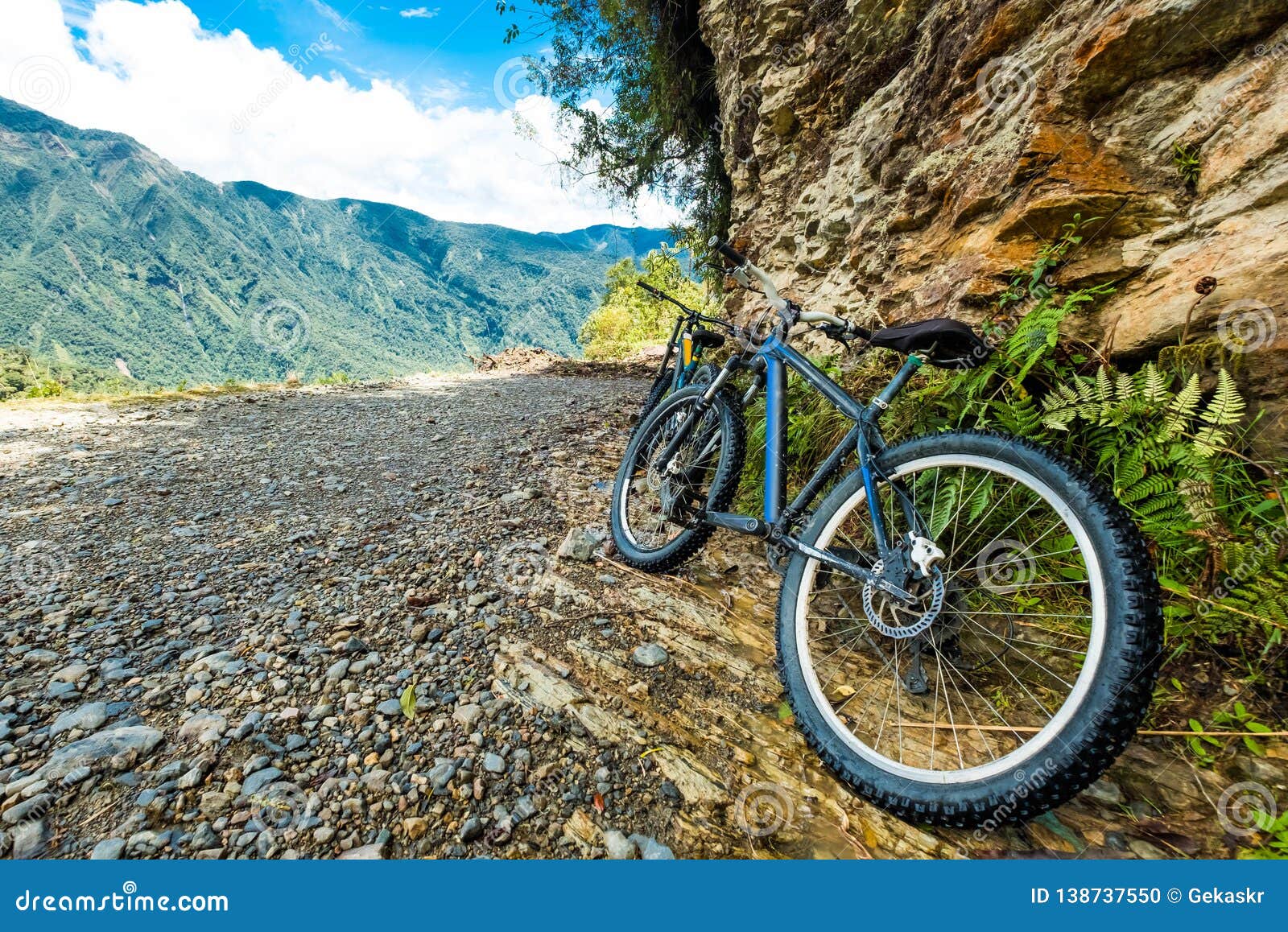 Black Mountain Bikes by the Rock Stock Photo - Image of effort ...