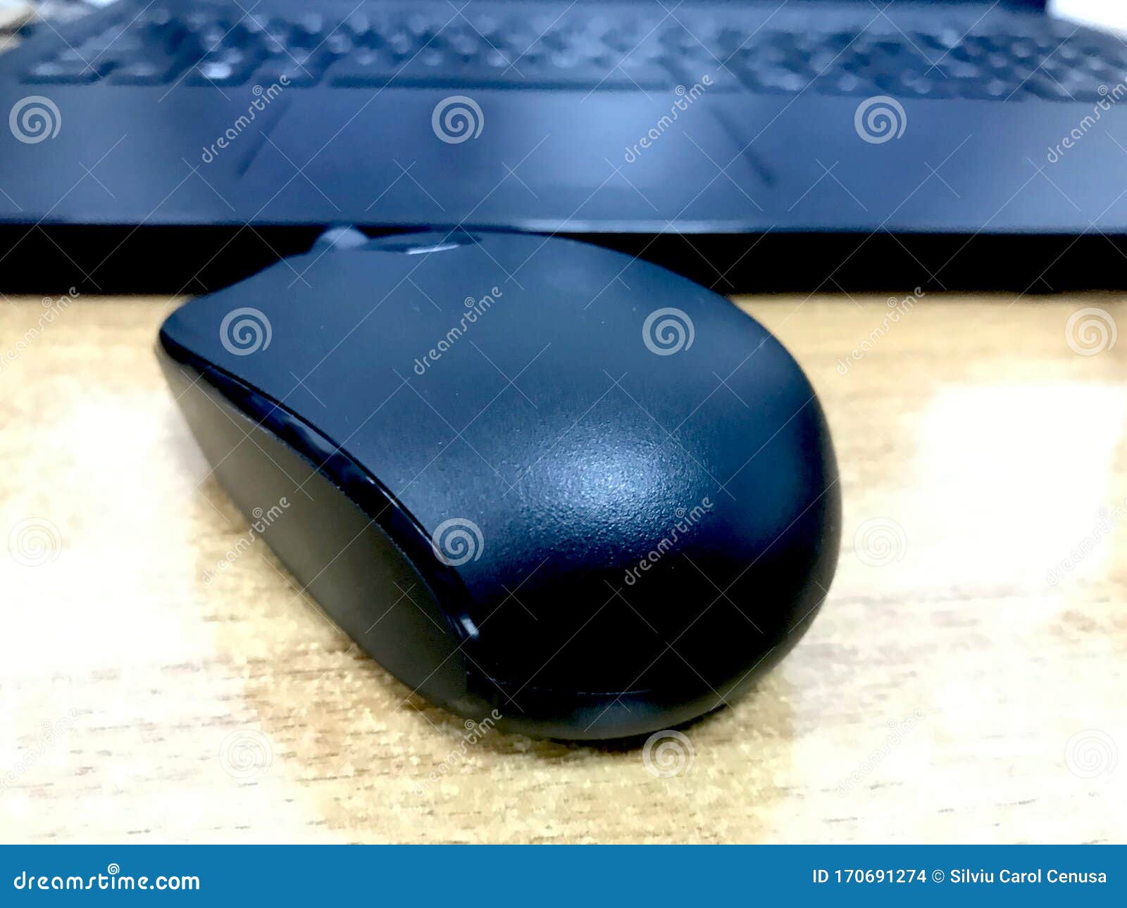 A Black Mouse with a Laptop Behind Stock Photo - Image of finger ...
