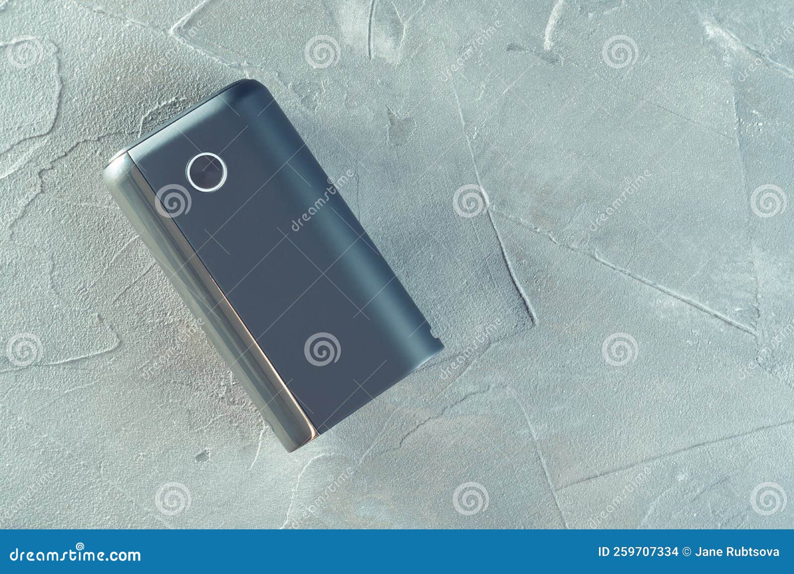 Black New GLO Heating Smoking Device on Gray Concrete Surface. Modern ...